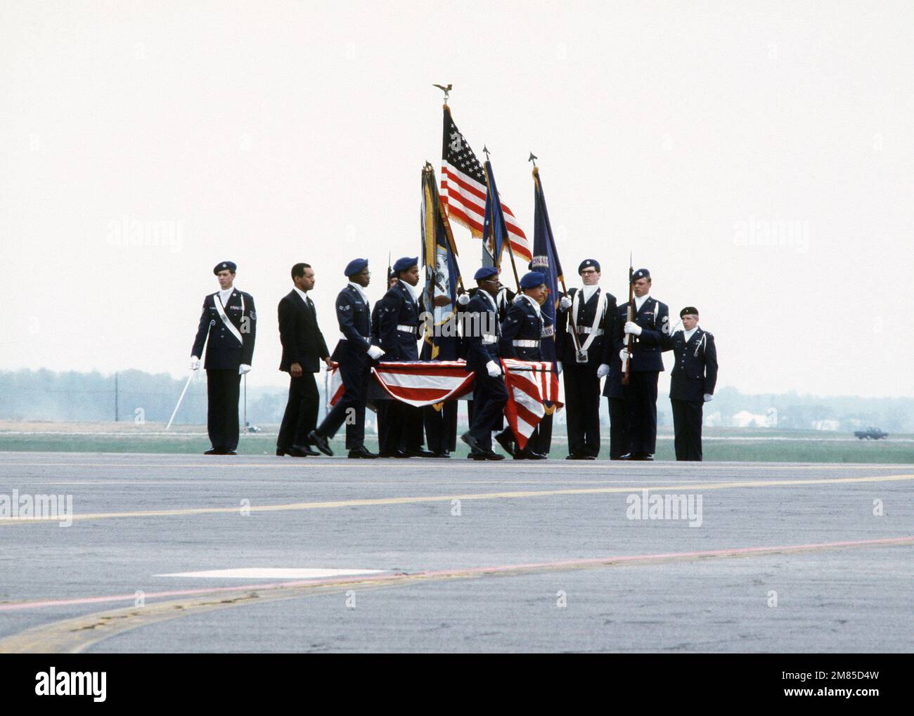 Air Force pallbearers carry a coffin containing the remains of a crew ...