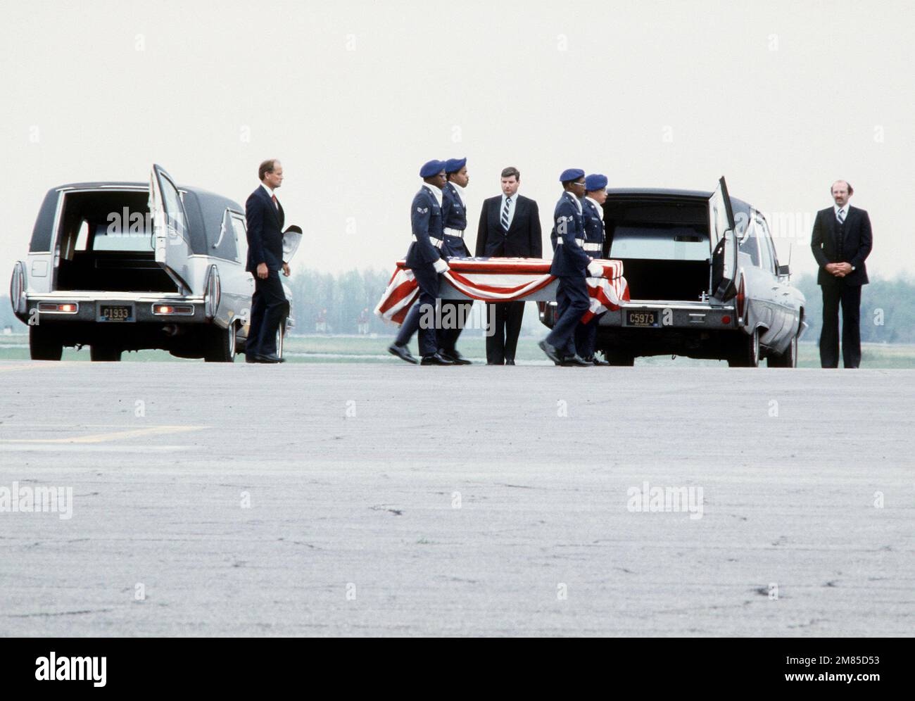 Air Force pallbearers carry a coffin containing the remains of a crew ...