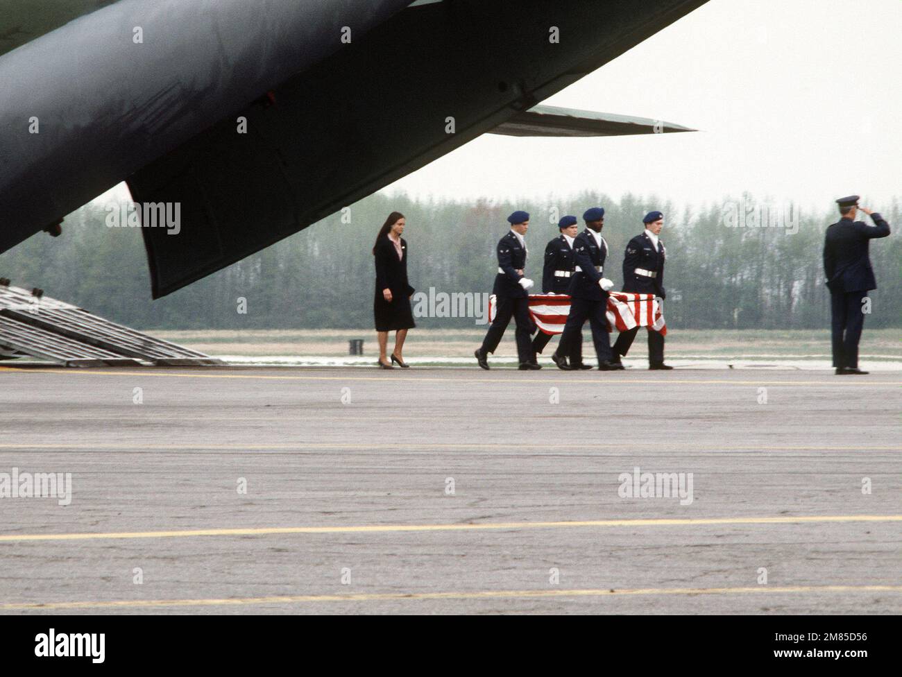 Air Force pallbearers carry a coffin containing the remains of a crew ...