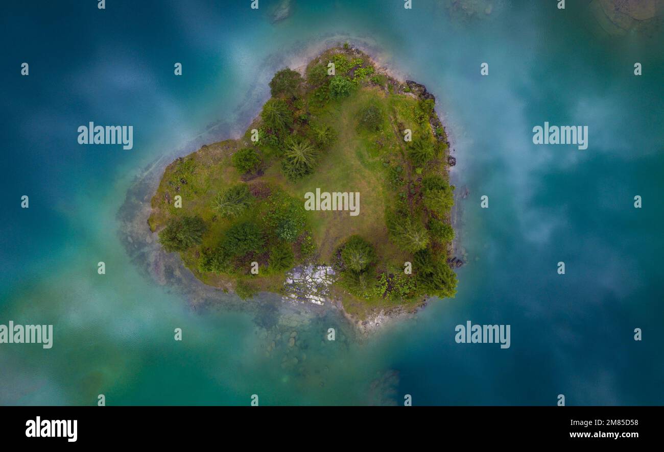 An aerial breathtaking view of a small heart-shaped island surrounded ...
