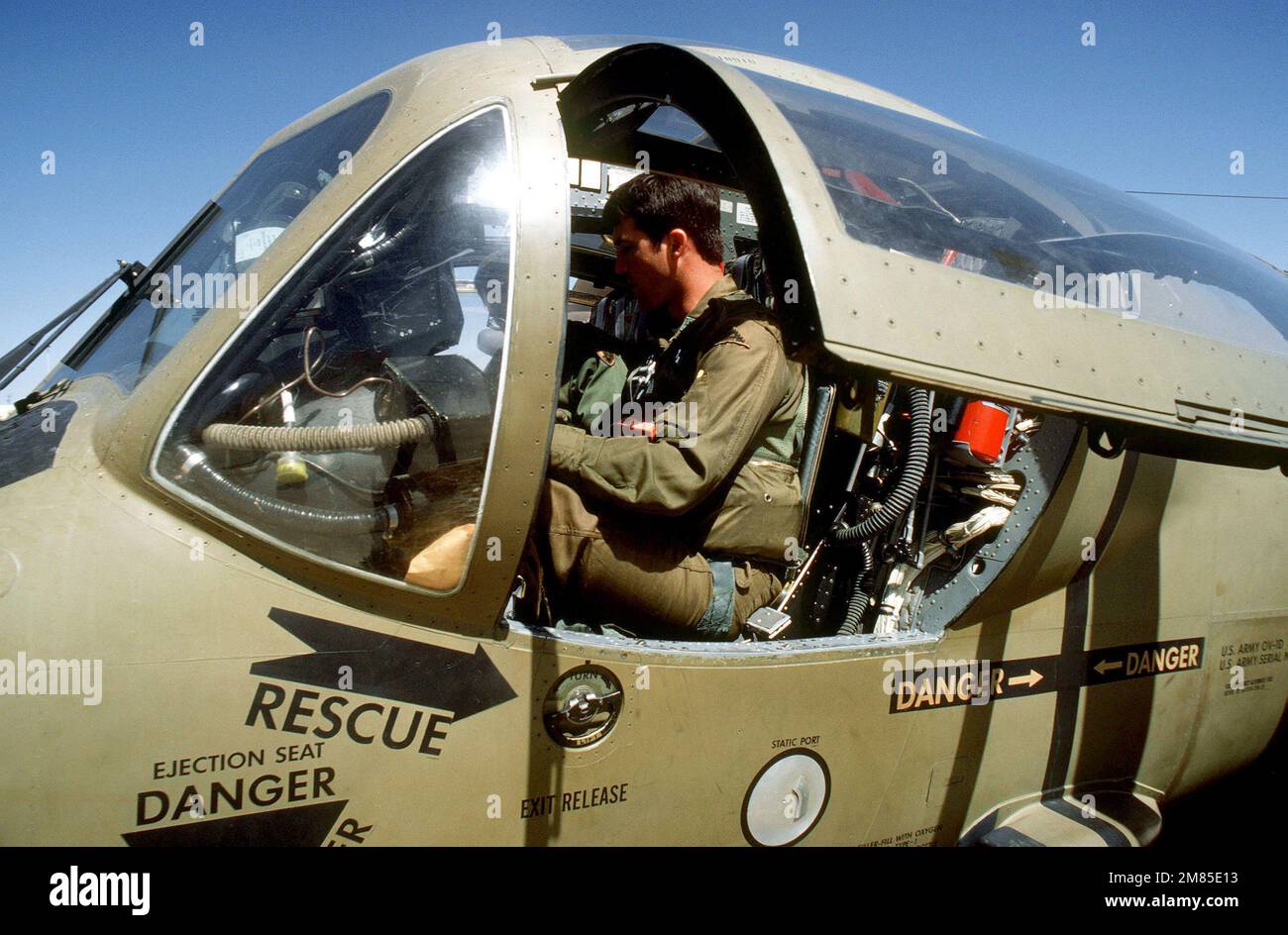 A U.S. Army pilot and copilot secure themselves in the cockpit of an OV ...