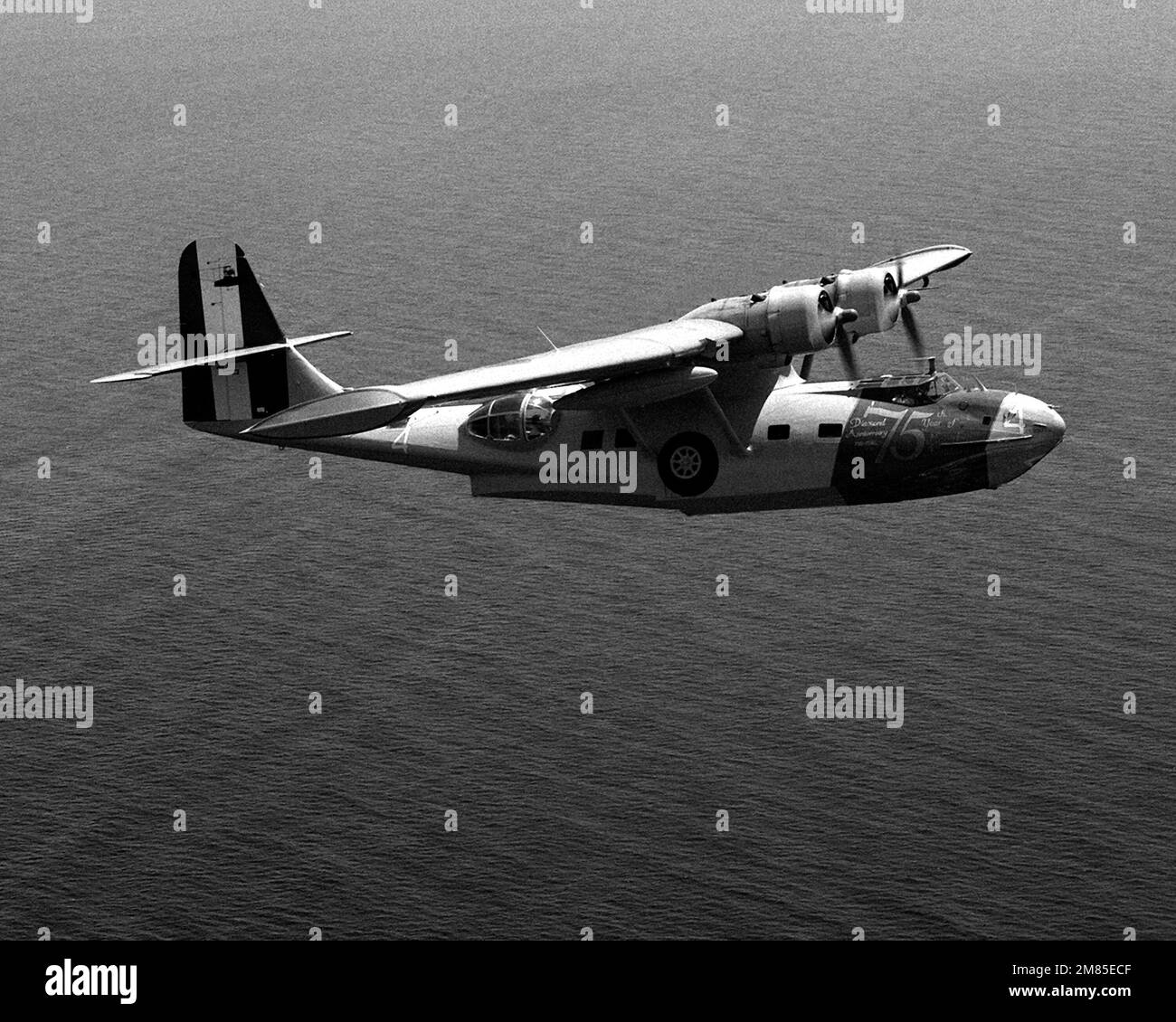 A right side view of a restored PBY Catalina aircraft in flight during ...