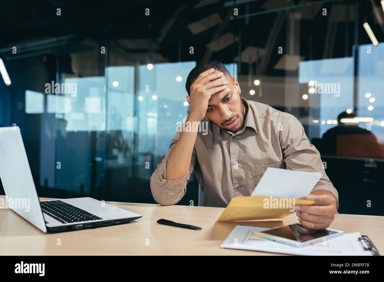 Pensive businessman inside office reading notification letter, man ...
