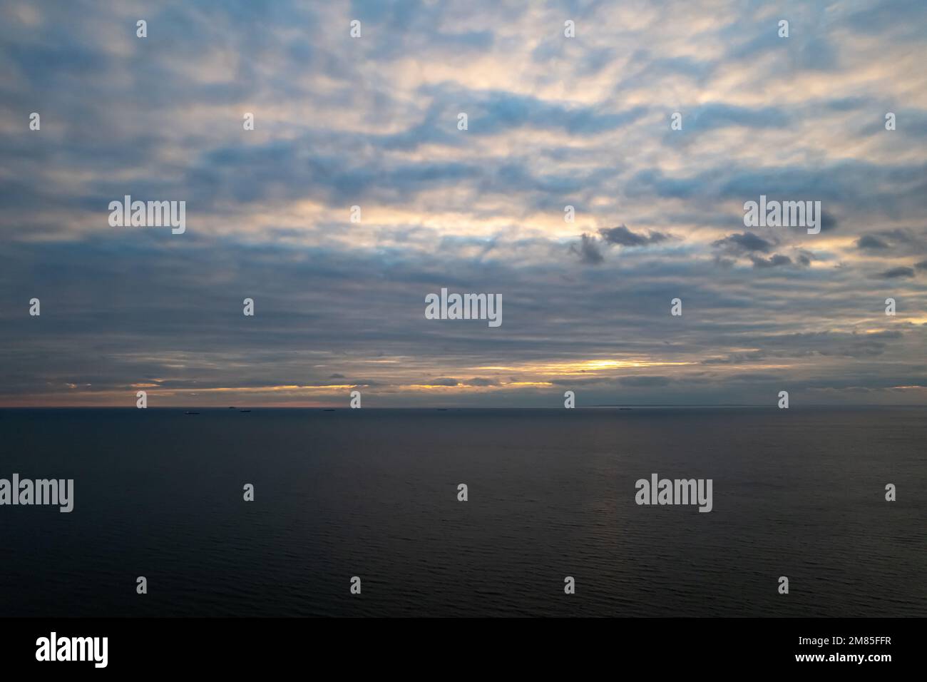 An aerial view of the seascape under cloudy dusk sky at sunset Stock ...
