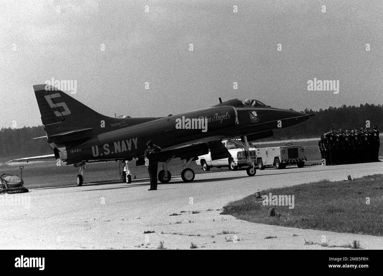 Ground crewmen salute as a Blue Angels Flight Demonstrated Squadron A ...