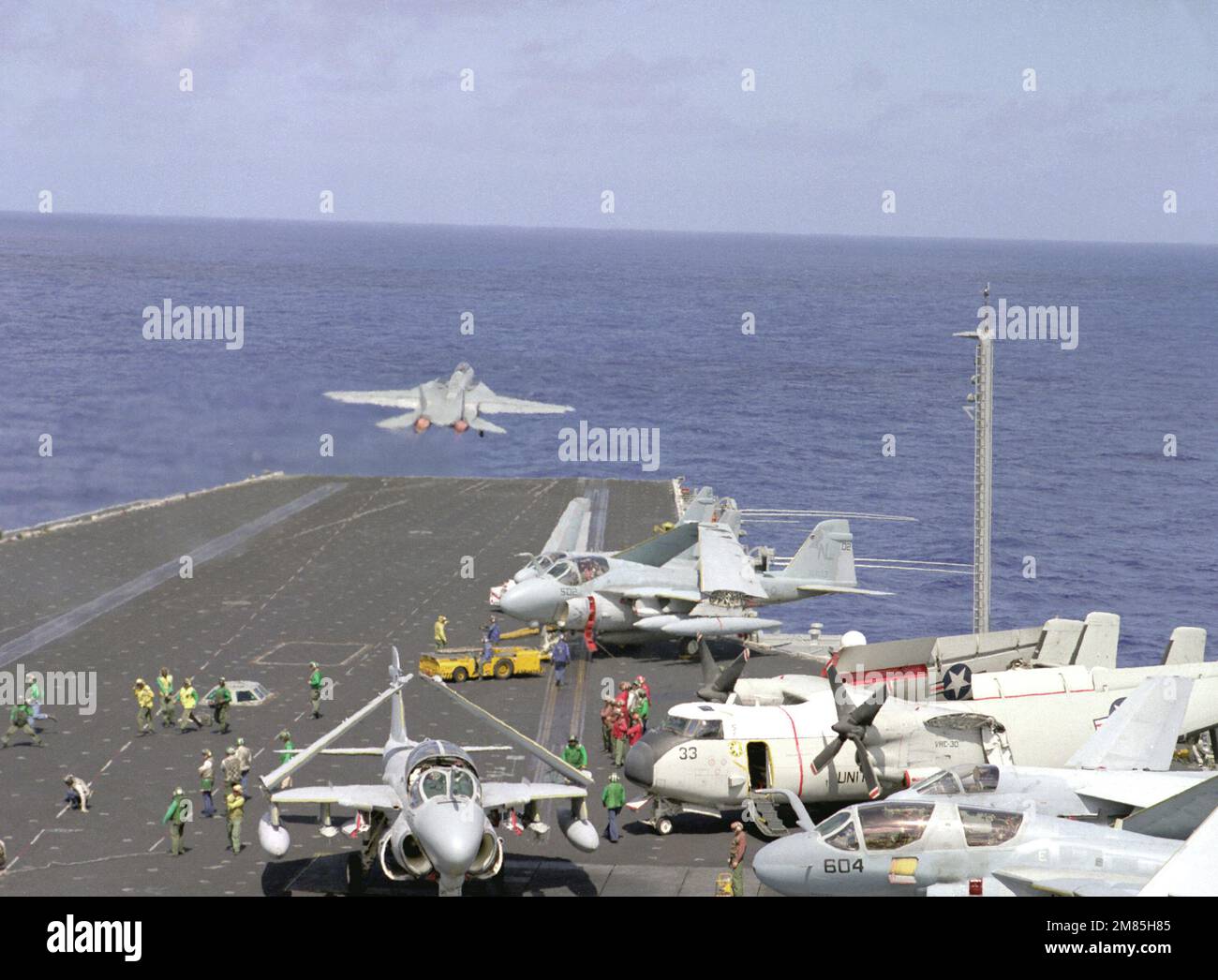 An F-14A Tomcat aircraft takes off during flight operations aboard the ...