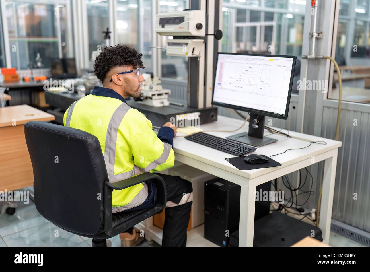 Engineer sitting in robot electronic room use computer create process ...