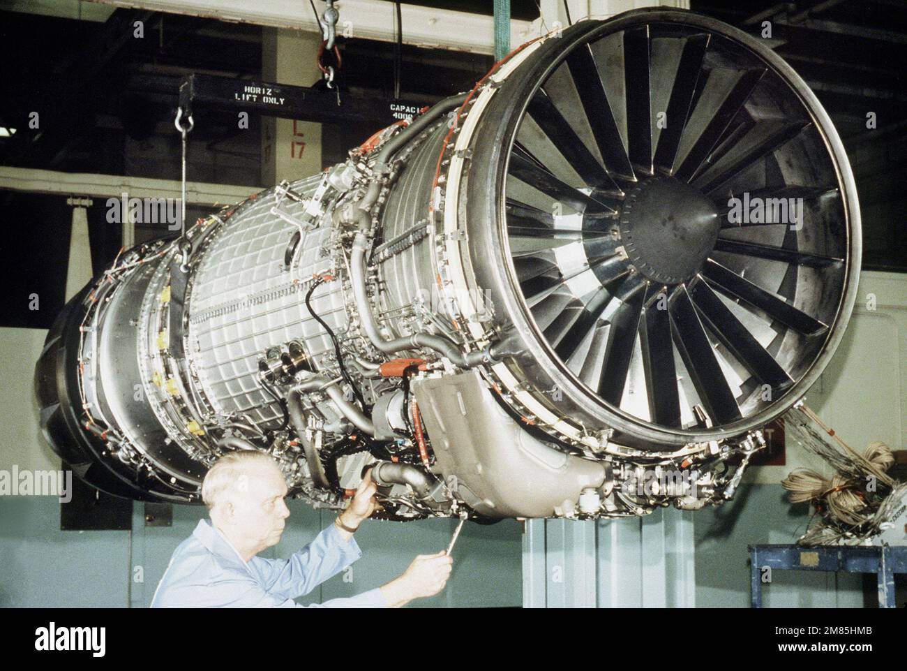 A technician works on the new F-110 turbofan engine to be used in the F ...