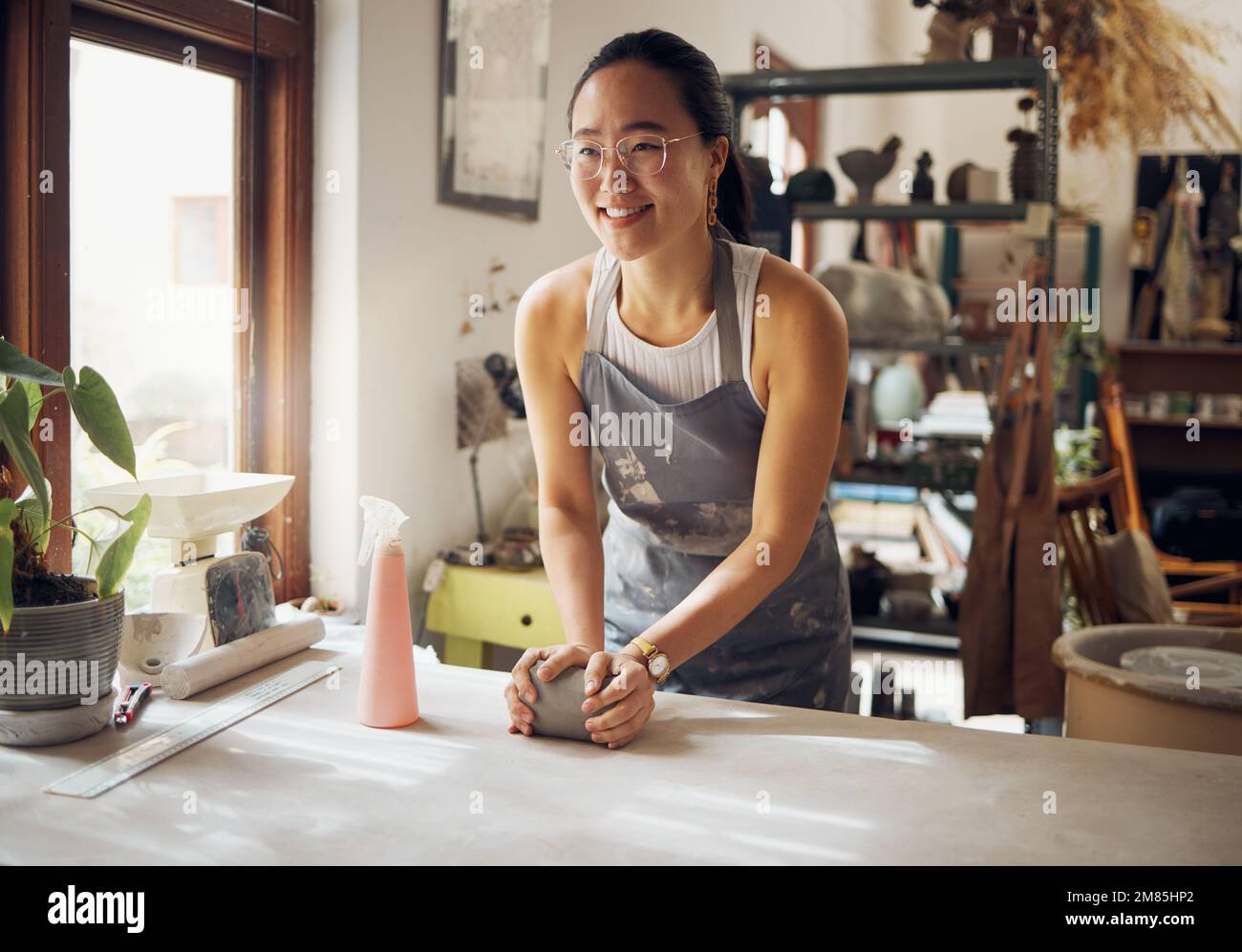 Asian, woman and artist in clay studio, workshop and creative startup ...