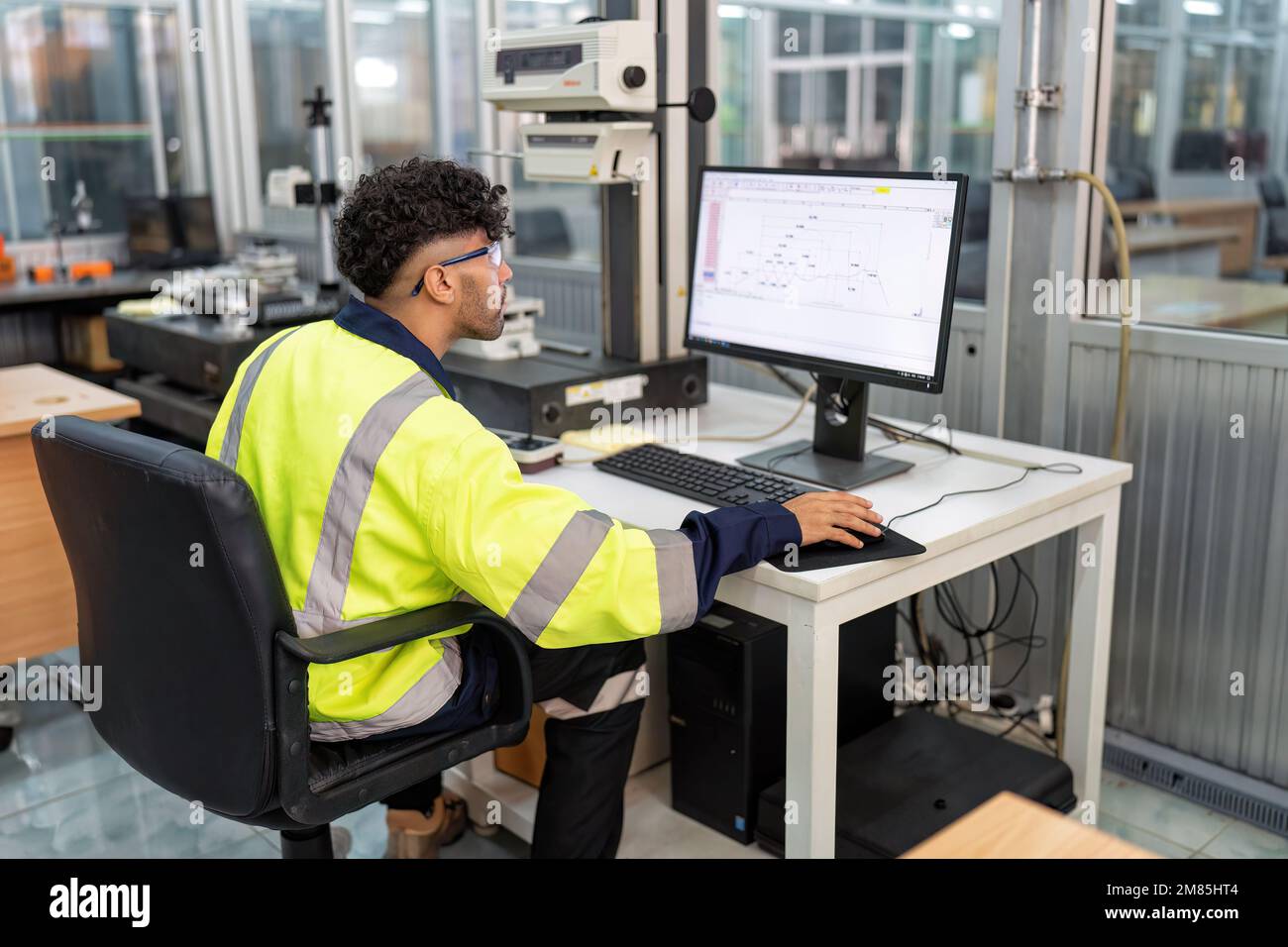 Engineer sitting in robot electronic room use computer create process ...
