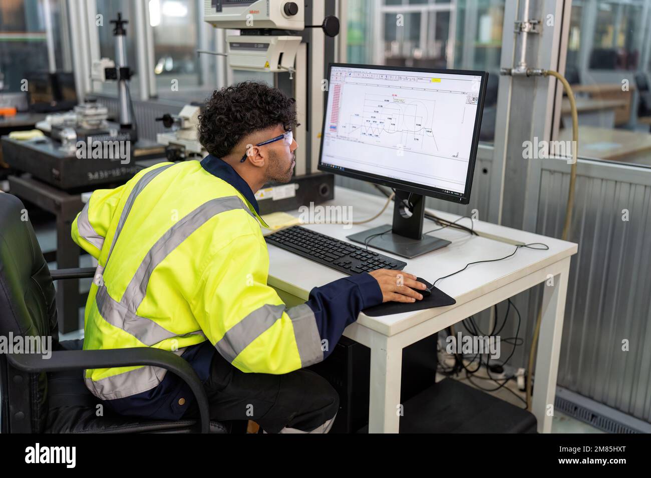 Engineer sitting in robot electronic room use computer create process ...