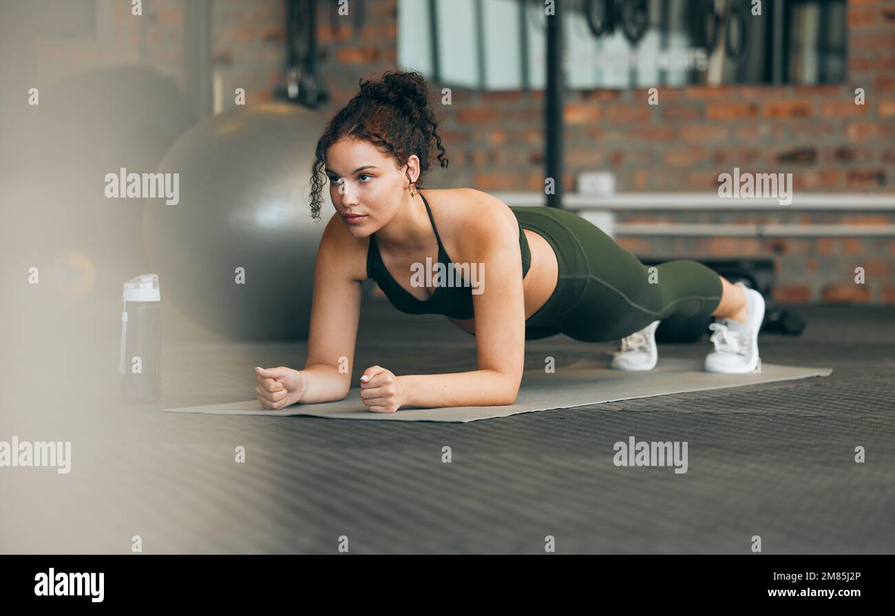 Fitness, gym and workout of a woman doing plank exercise or training ...