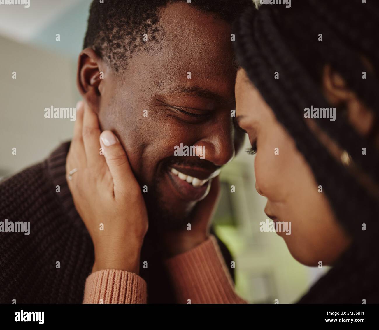 Black couple, face and love while together at home with care and ...
