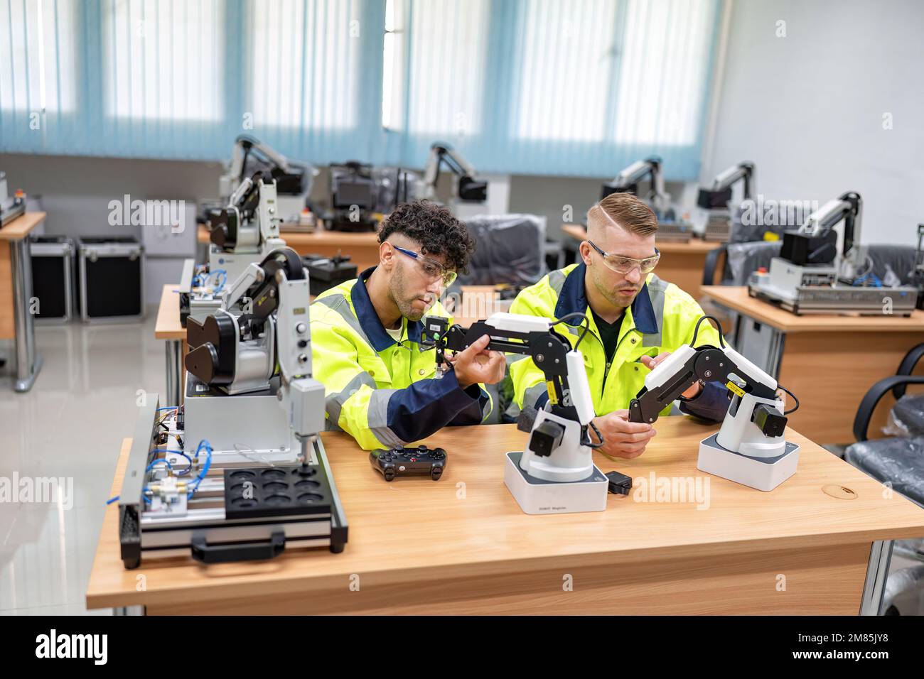 Engineer learn basic theory how to operation maintenance and programing robot arm in training ...
