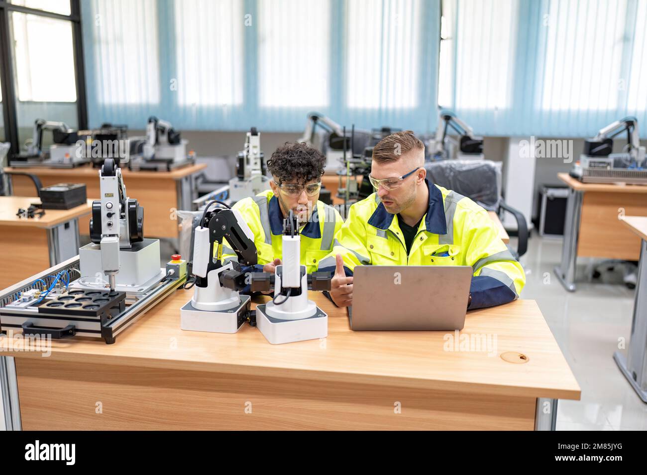 Engineer learn basic theory how to operation maintenance and programing robot arm in training ...