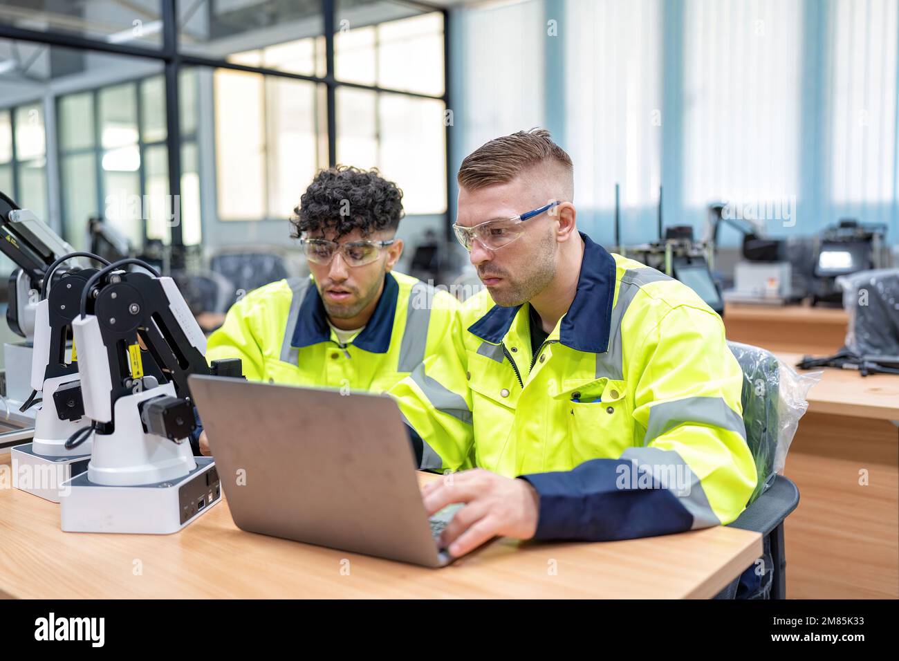 Engineer learn basic theory how to operation maintenance and programing robot arm in training ...