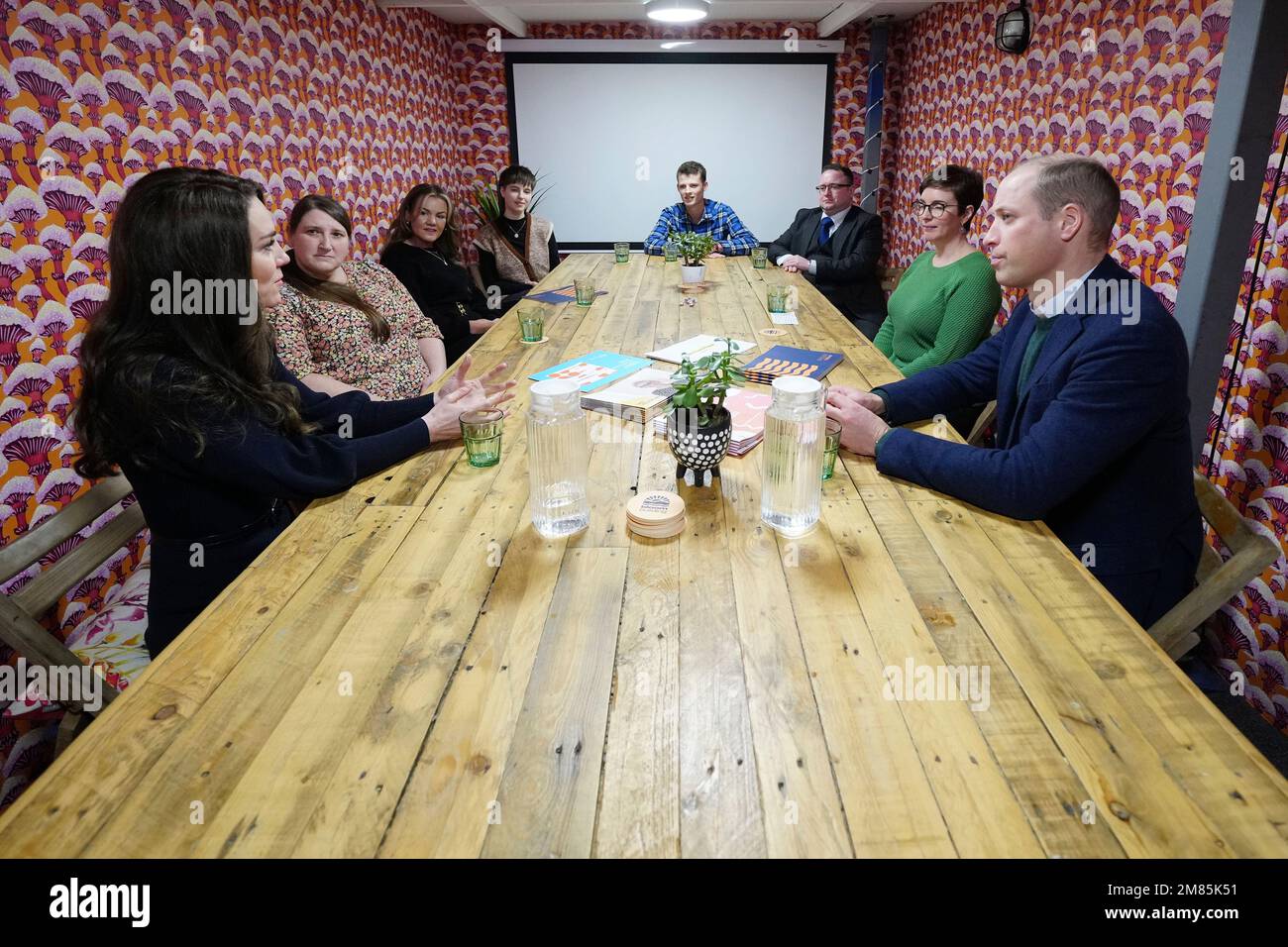 Britain's Kate, Princess of Wales, and Prince William listen to staff ...