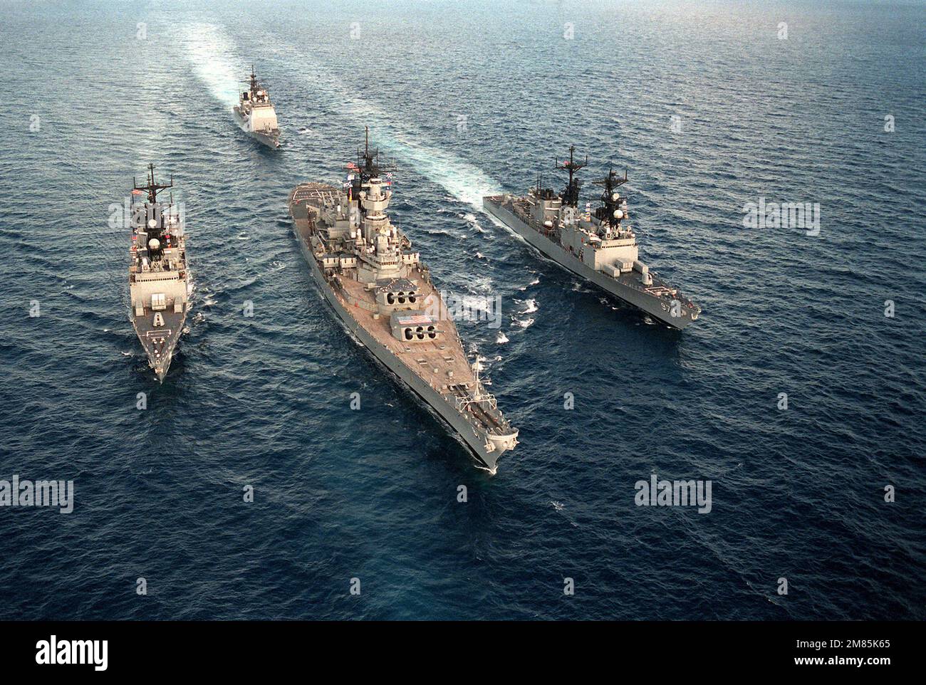 An aerial starboard bow view of the destroyer USS DEYO (DD-989); the battleship USS IOWA (BB-61 ...