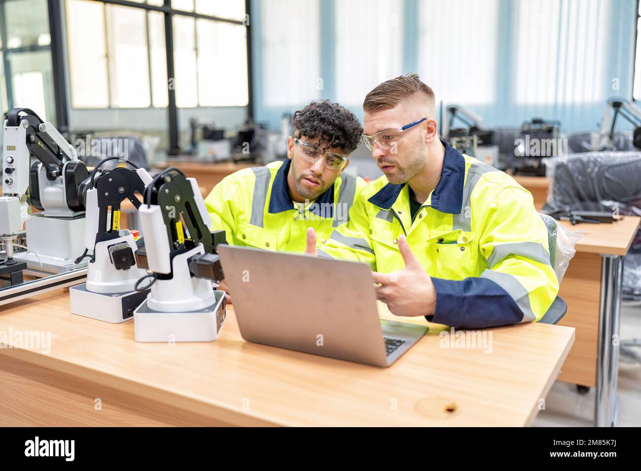 Engineer learn basic theory how to operation maintenance and programing robot arm in training ...