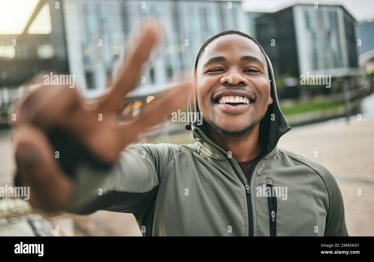 Fitness, selfie and portrait of a black man with peace sign in the city doing a cardio exercise ...