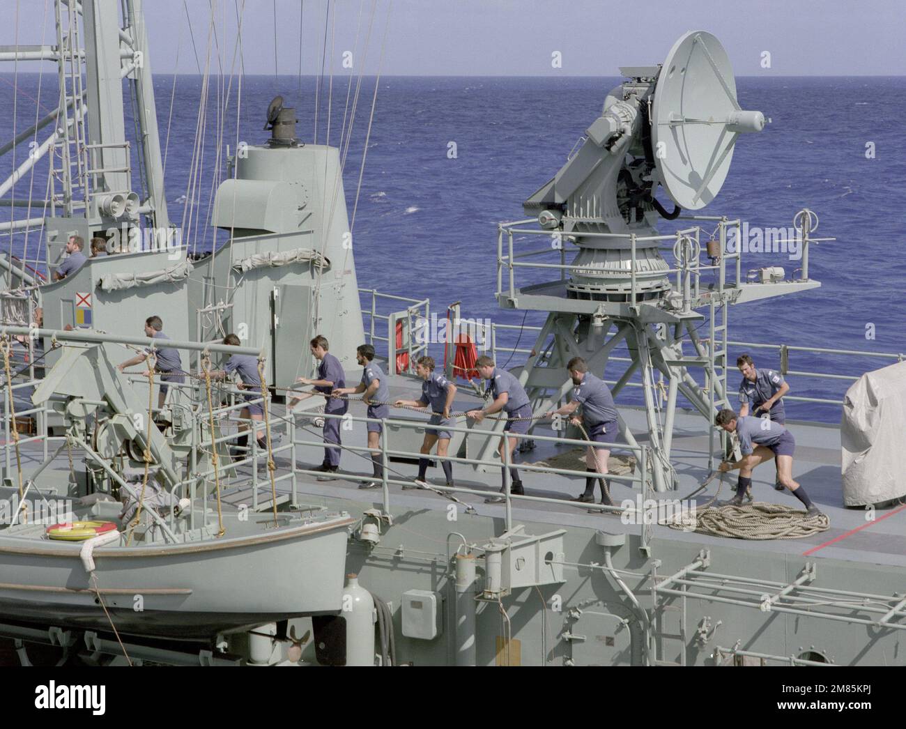 Crew members haul on a line aboard the Australian guided missile ...