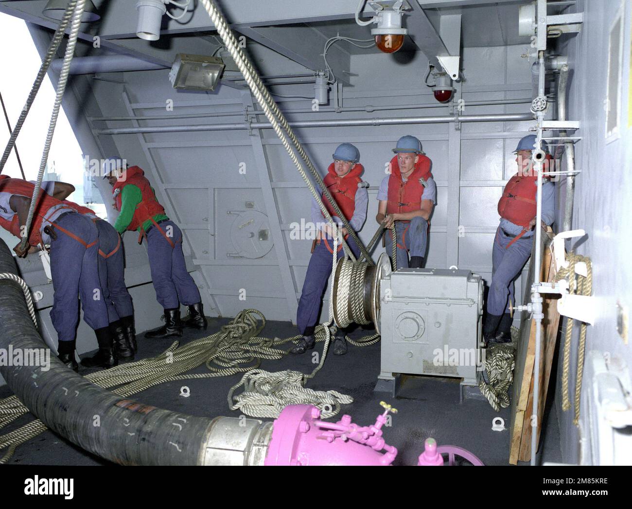 Crewmen work at a refueling station aboard the nuclear-powered aircraft ...