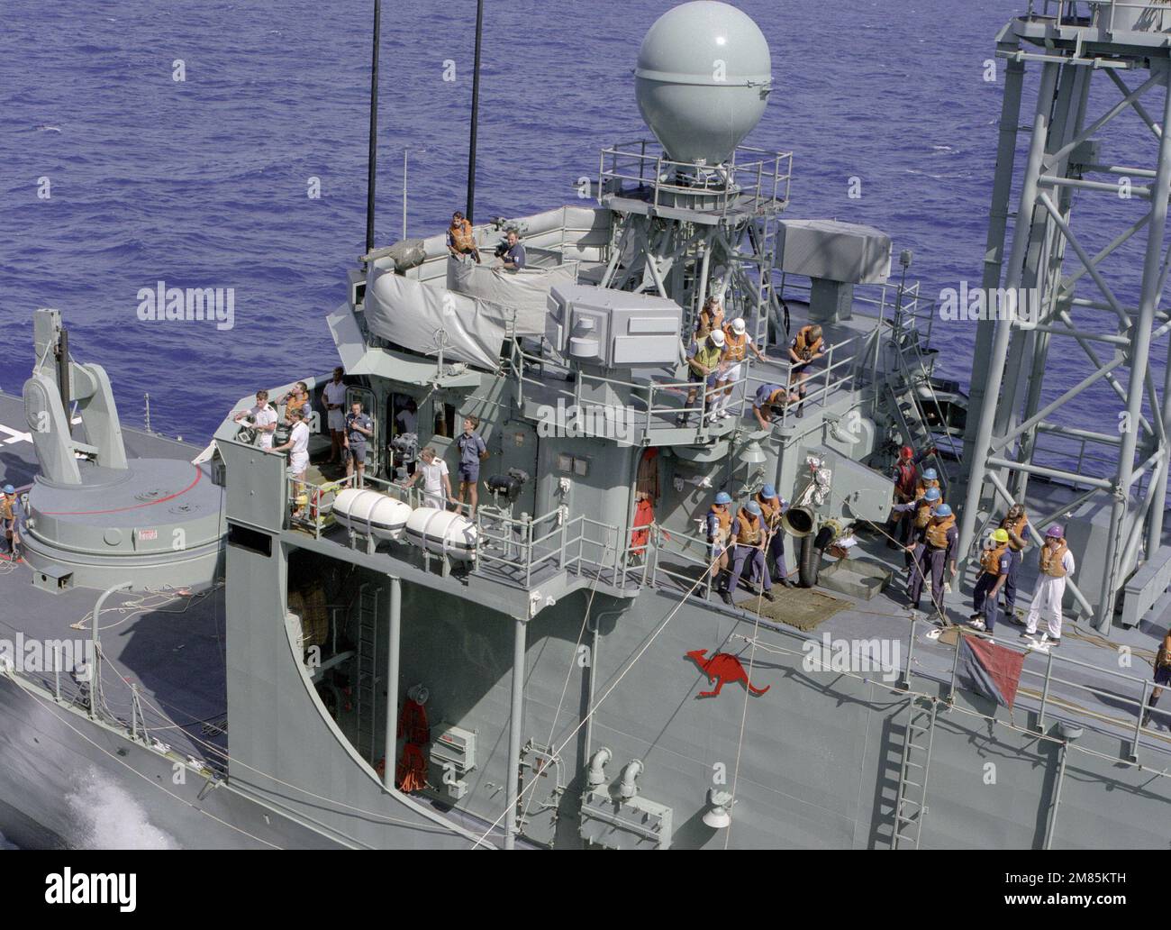 Crew members haul on a line aboard the Australian guided missile ...