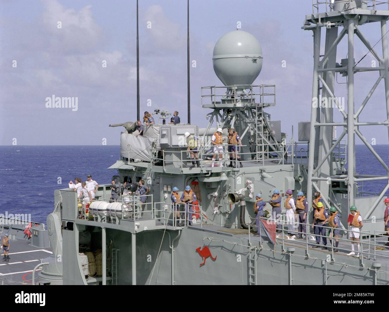 Crew members stand by aboard the Australian guided missile frigate HMAS ...
