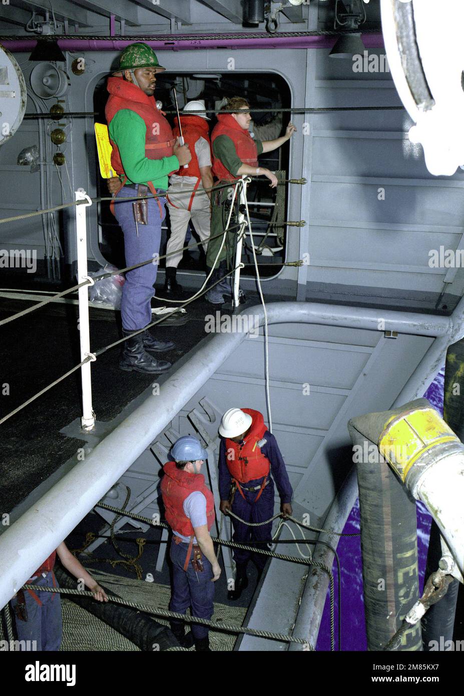 Crewmen work at a refueling station aboard the nuclear-powered aircraft ...