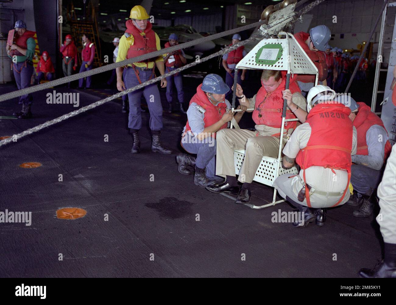 A crewman from the frigate USS BREWTON (FF-1086) is secured in a ...