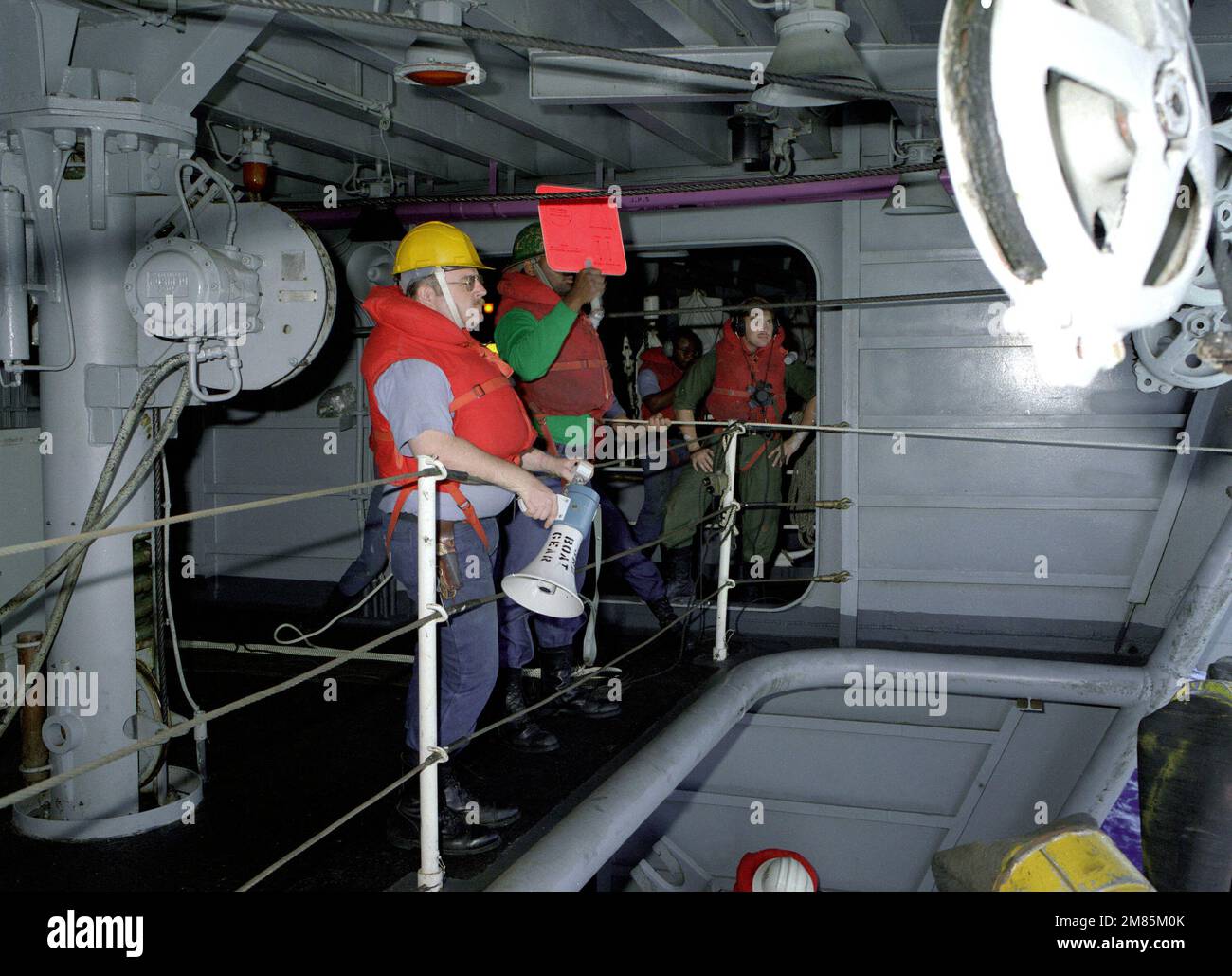 Crewmen work at a refueling station aboard the nuclear-powered aircraft ...