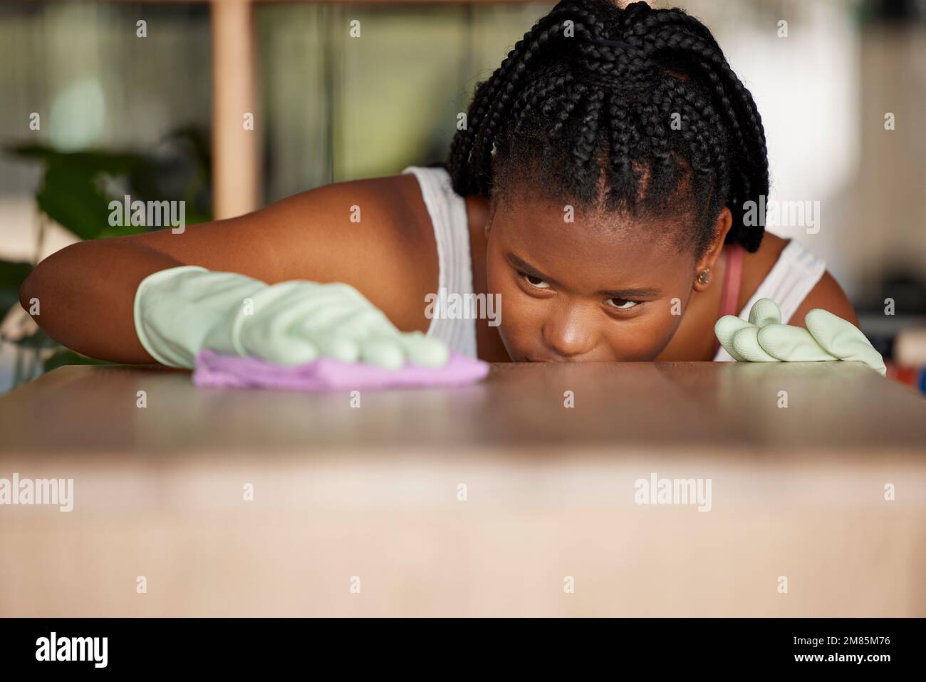 Housework, cleaning and black woman with cloth, table wash and surface ...