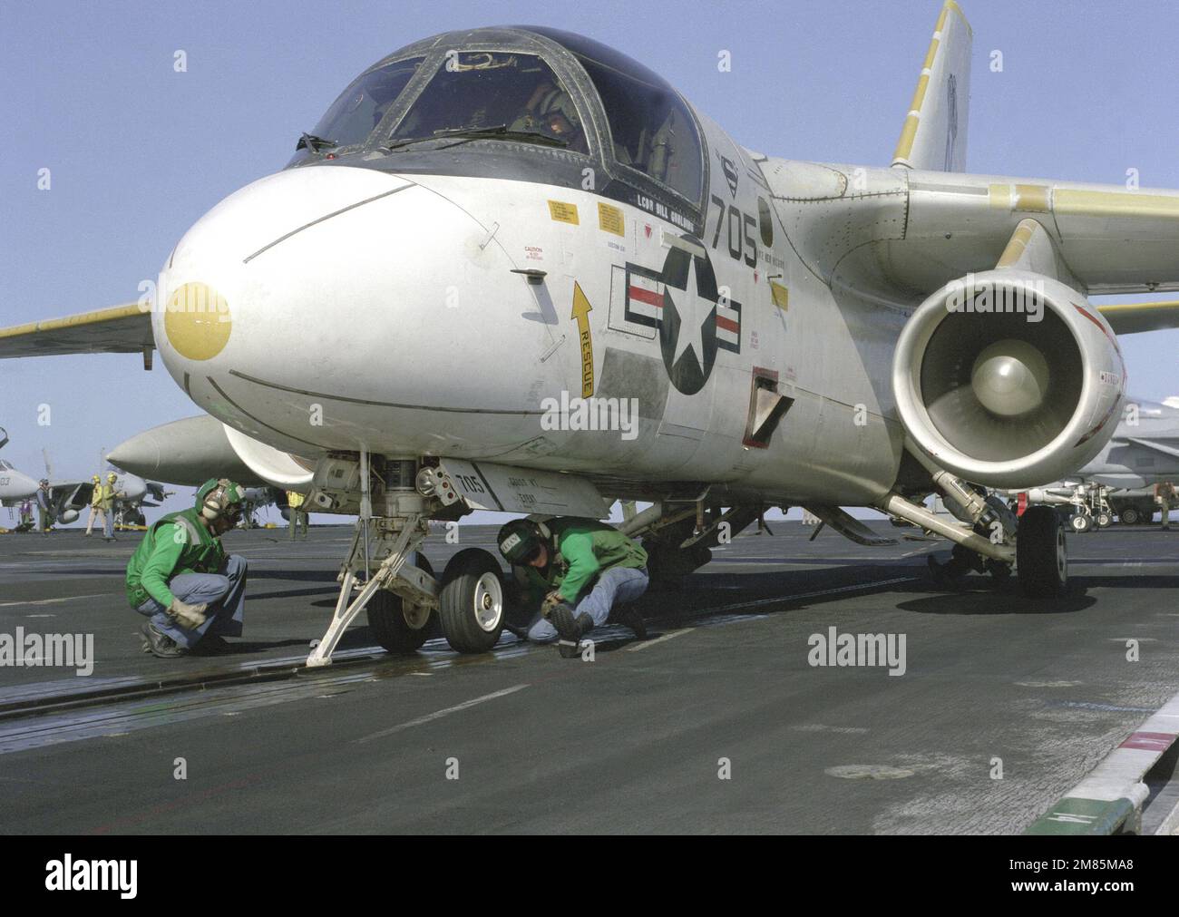 Flight deck crewmen attach an S-3A Viking aircraft to a catapult during ...