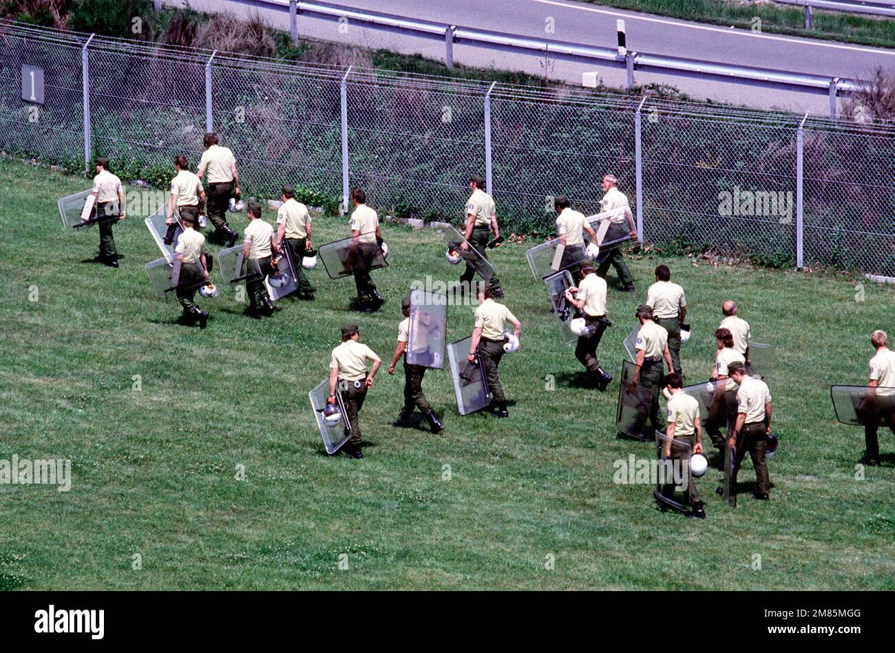 German police with riot gear head for the base's main entrance to join ...