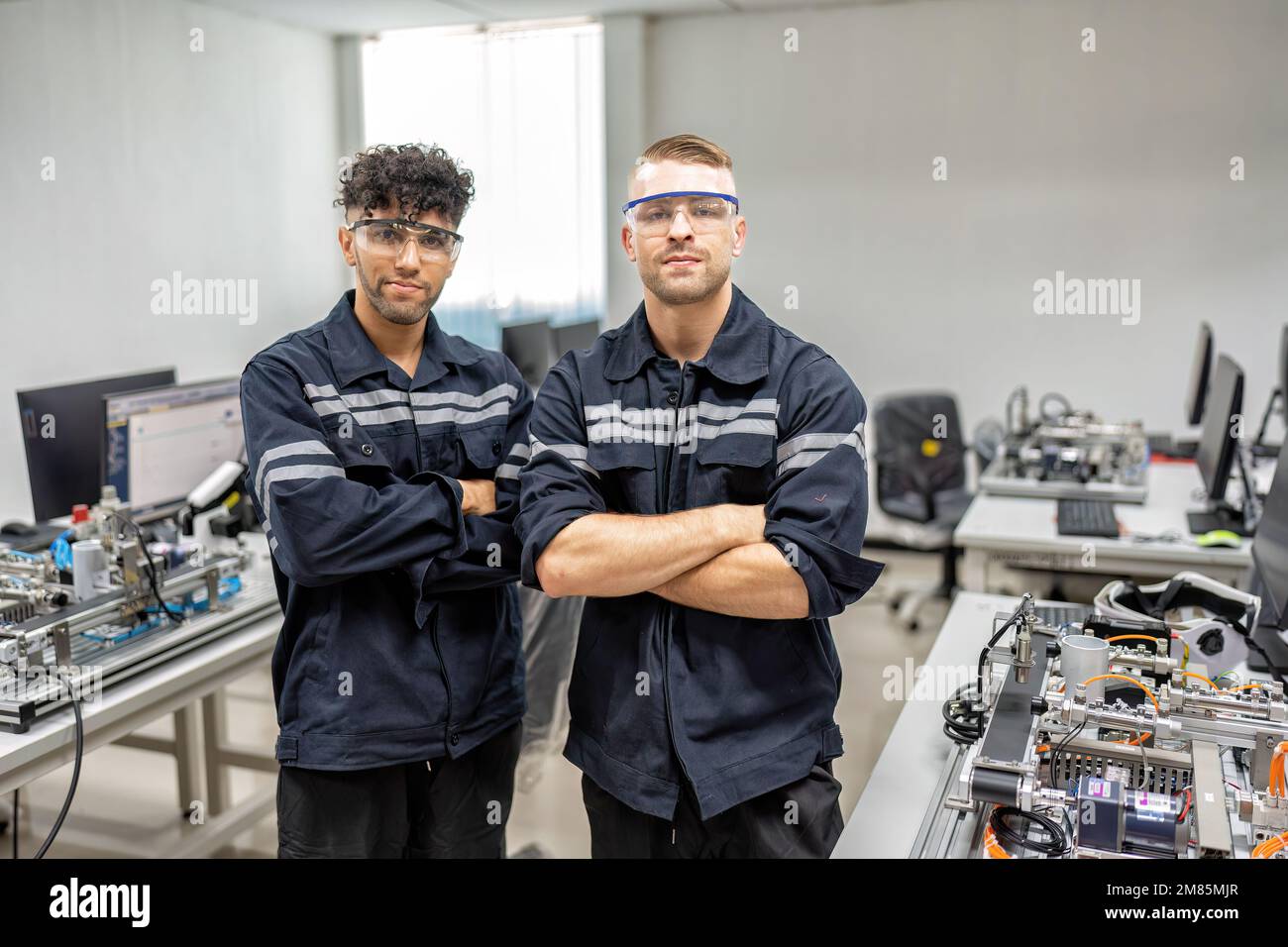 Engineer stand in robot fabrication room quality checking electronic ...