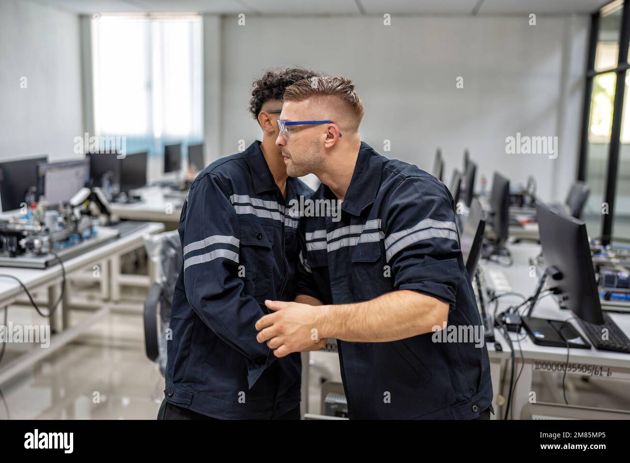 Engineer stand in robot fabrication room quality checking electronic ...