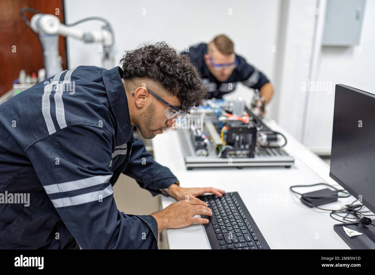 Engineer stand in robot fabrication room quality checking electronic ...