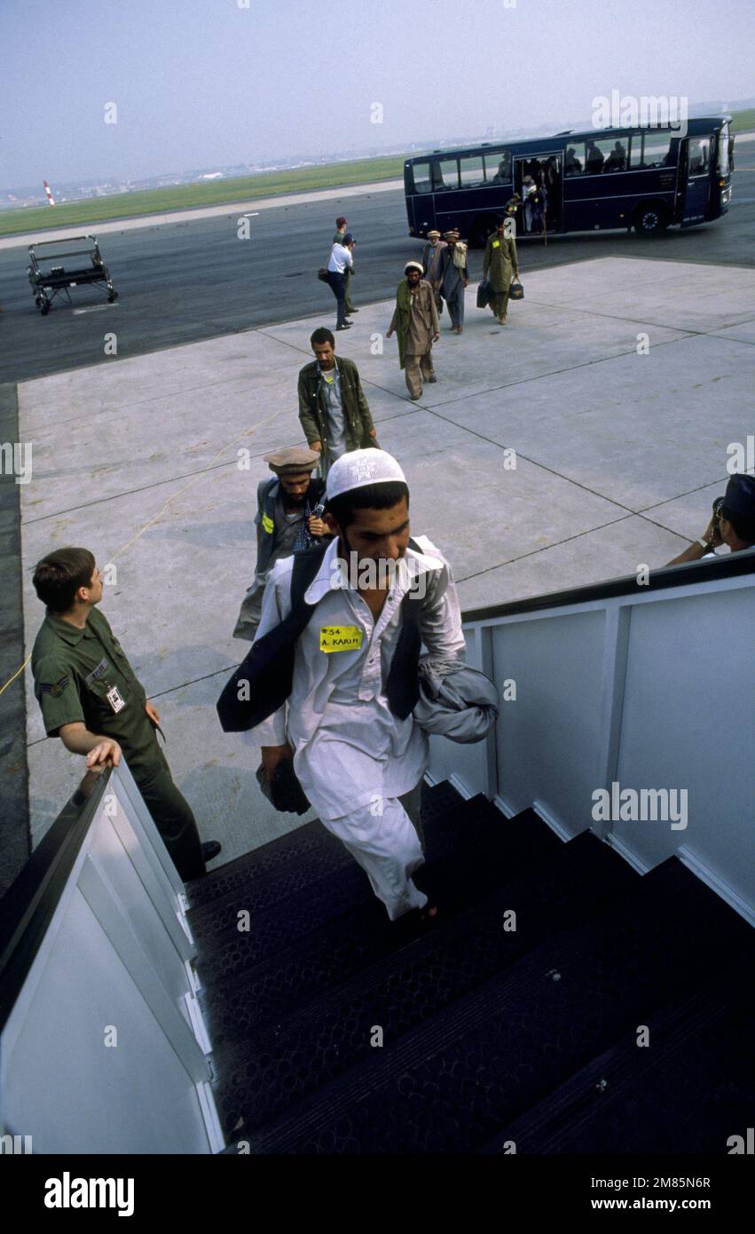 Afghanistani refugees walk from Air Force ambulance bus up the ramp of ...