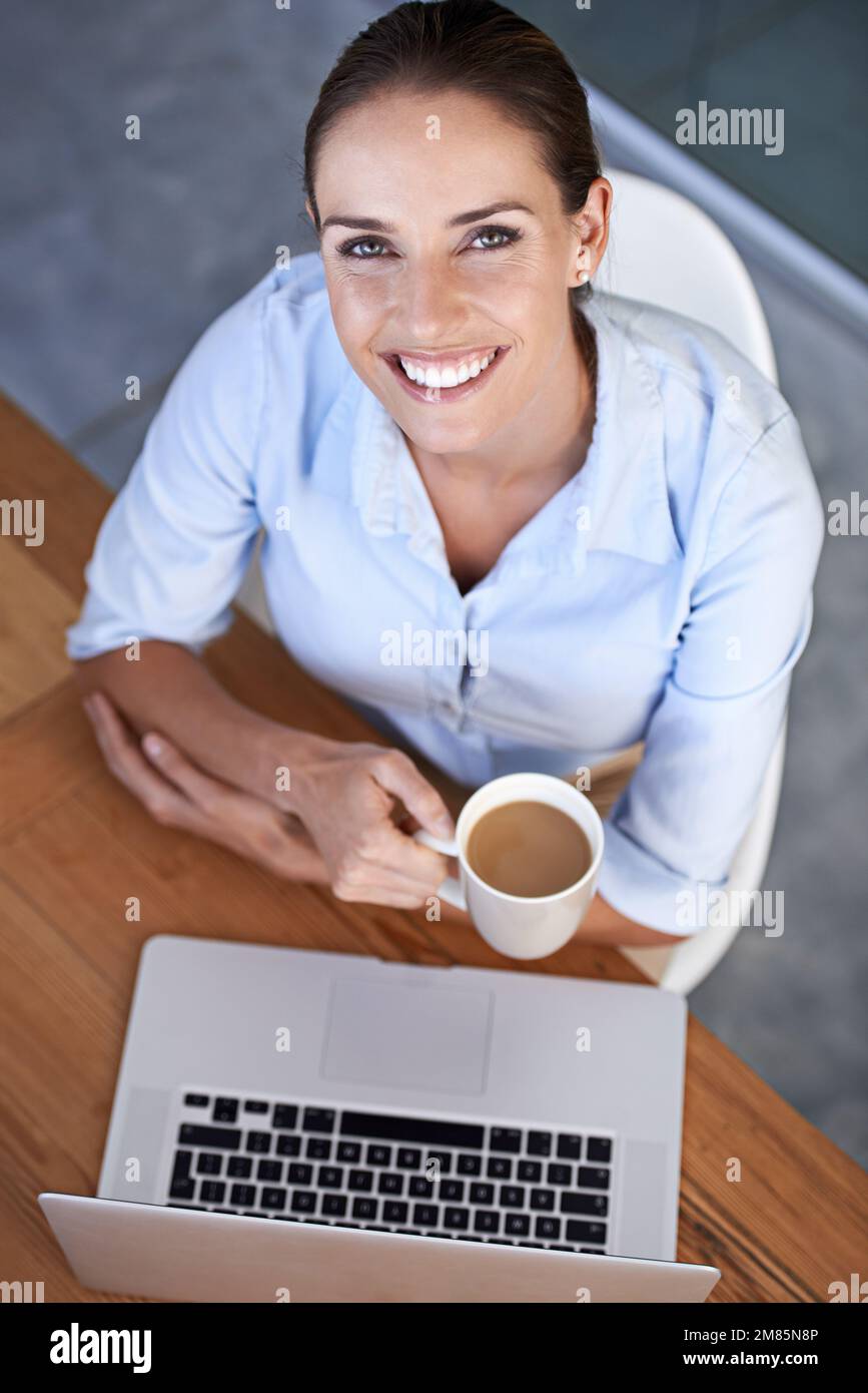 Enjoying a much needed cup o joe. High angle portrait of a young ...