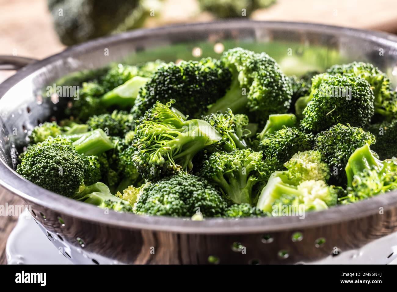 Steamed broccoli in a stainless steel steamer - Close up. Healthy ...