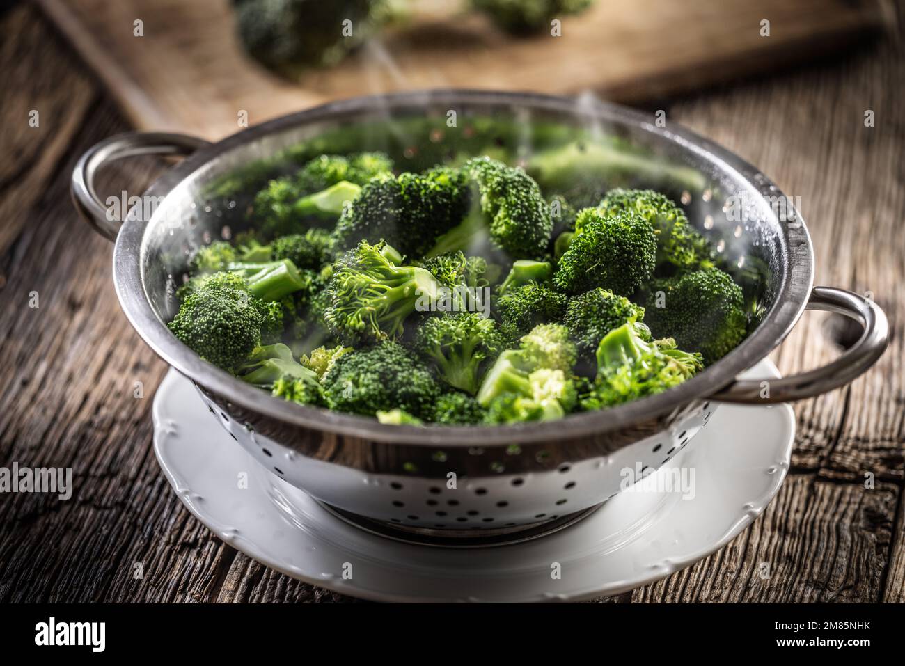 Steamed broccoli in a stainless steel steamer. Healthy vegetable ...