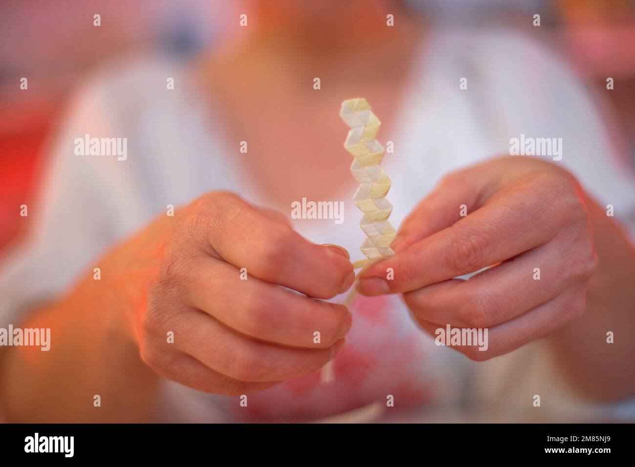 The woman's hands weave straw. traditional craft Stock Photo - Alamy