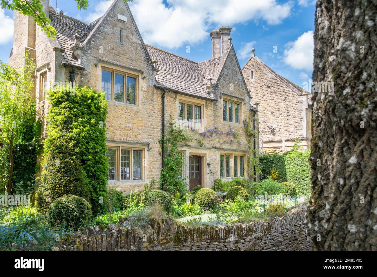A honey coloured stone cottage with 2 gables overlooking the front ...