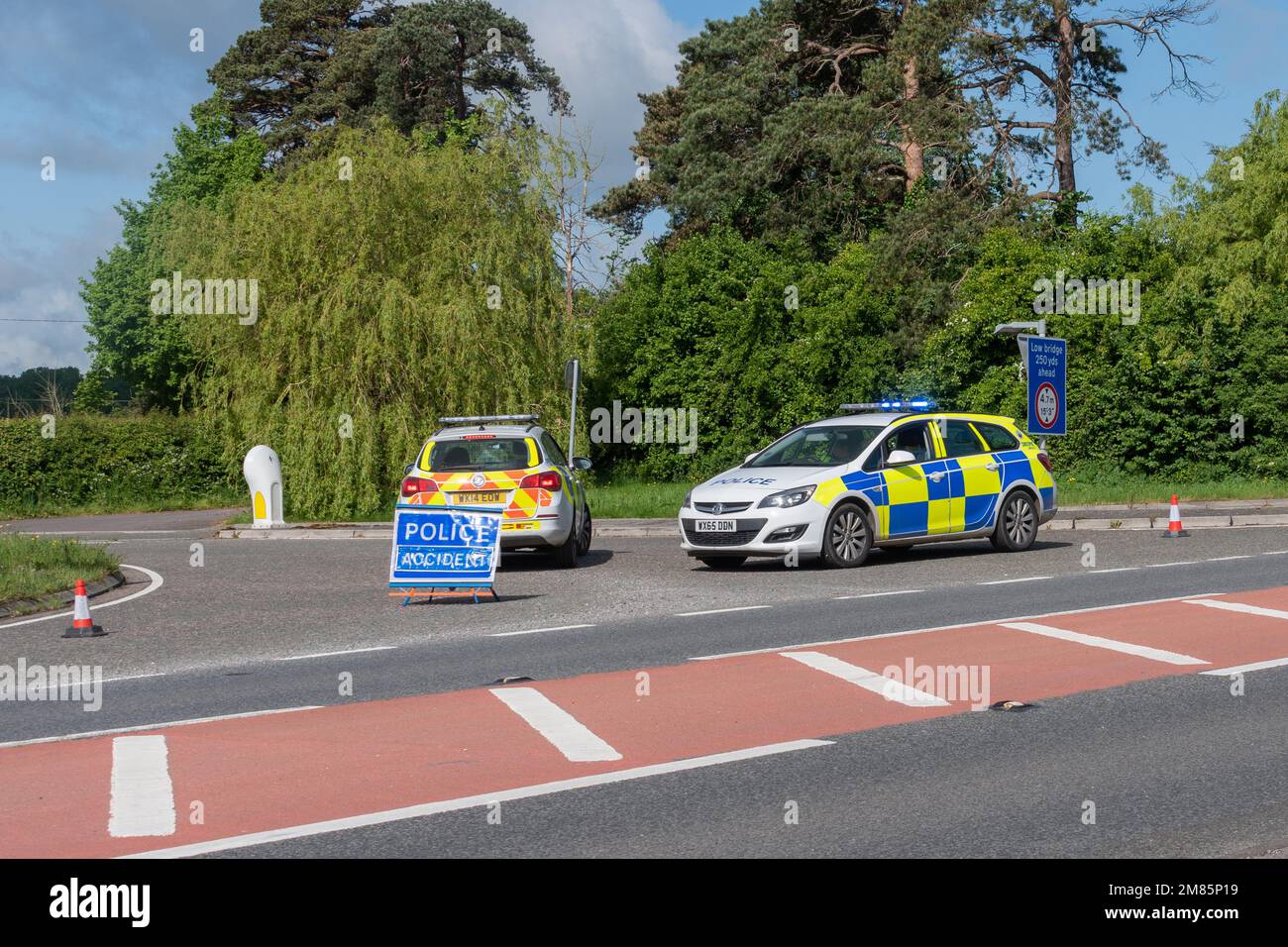 2 police cars on a road junction in Somerset with traffic cones and a ...