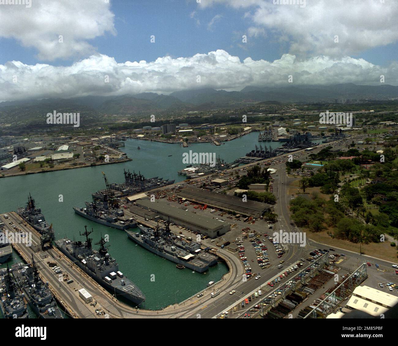 An aerial view of the Naval Shipyard with various ships moored to piers ...