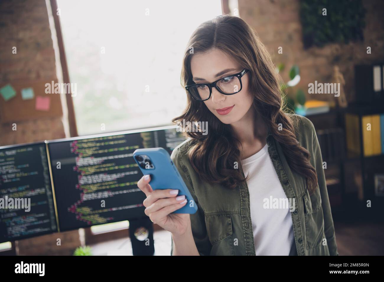 Photo of serious confident clever lady use telephone read proposition create new program ...