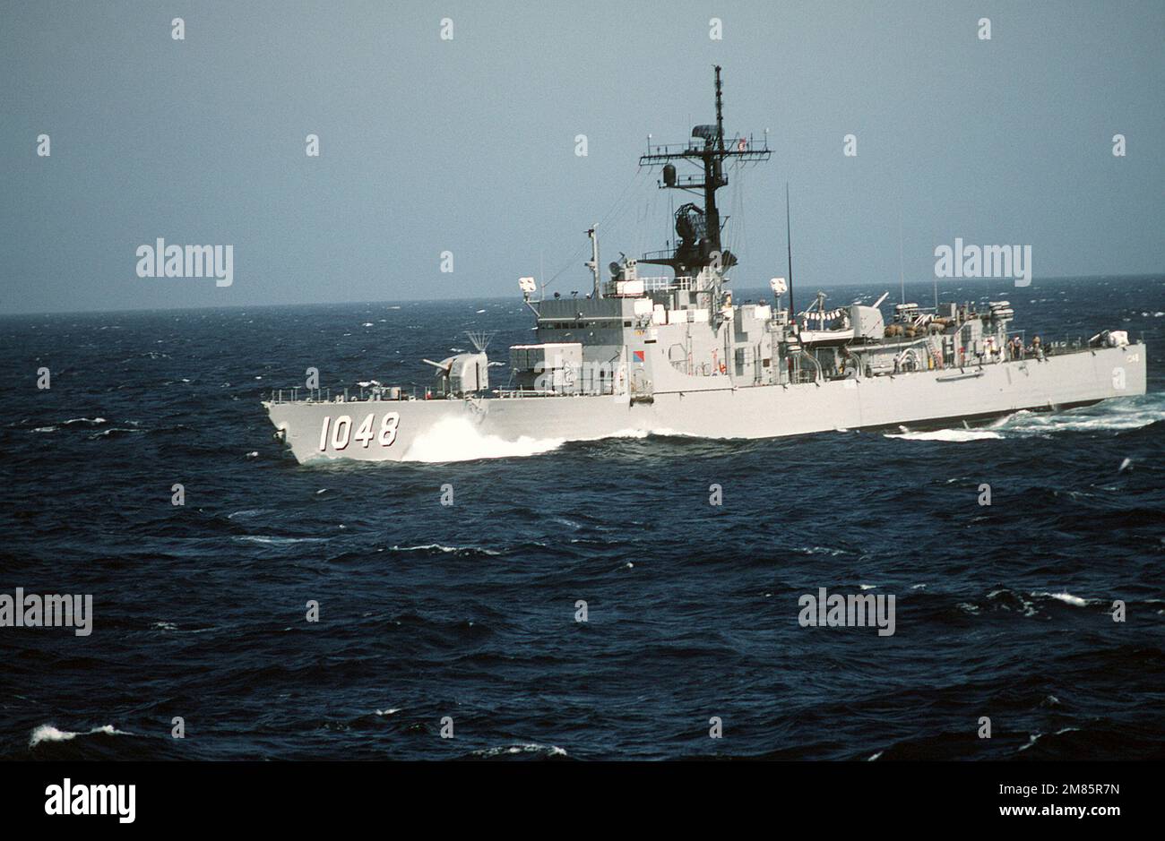 A port bow view of the frigate USS SAMPLE (FF-1048) underway during a ...