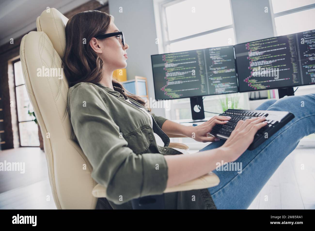 Photo of intelligent cool lady programmer wear spectacles coding new application indoors ...