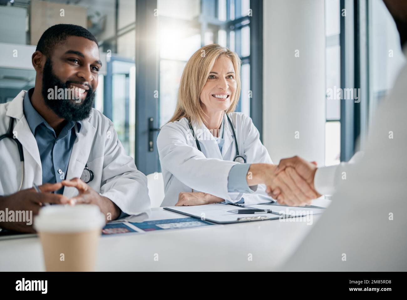 Handshake, partnership or happy doctors in a meeting after successful medical surgery or ...