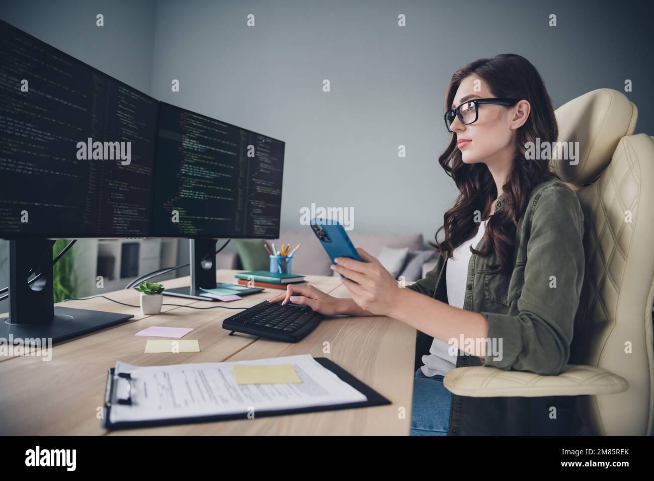 Profile side photo of serious smart lady pc operator hold telephone ...